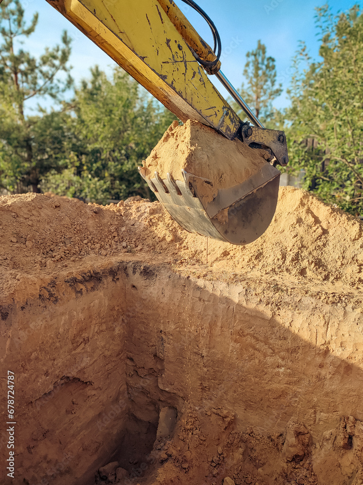 Digging the pit foundation a hole with excavator at the construction ...