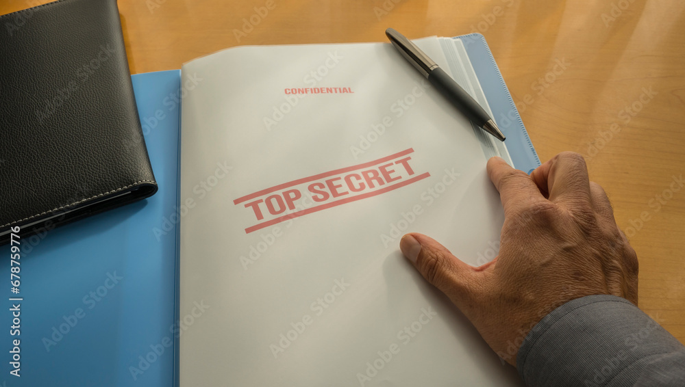 Hand of a man opening a folder with top secret documents. Confidential ...