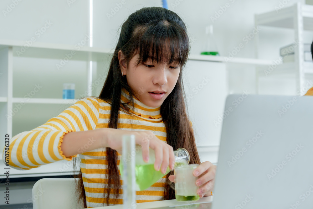 Cute female student is taking special science class during weekend ...