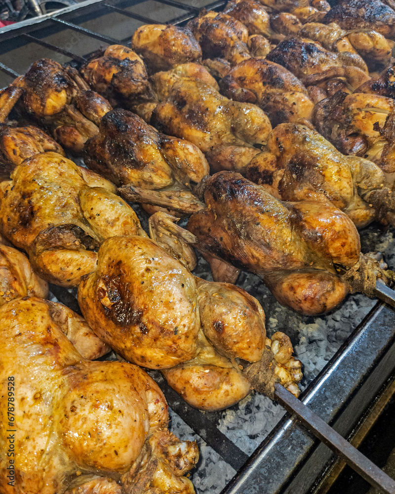 Authentic food chicken sajji. whole chicken is cooked on a skewer over ...