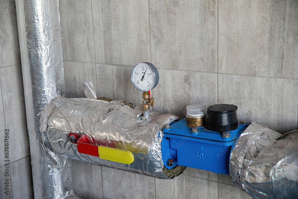 A pressure gauge in the pipe and a valve for opening and closing the ...