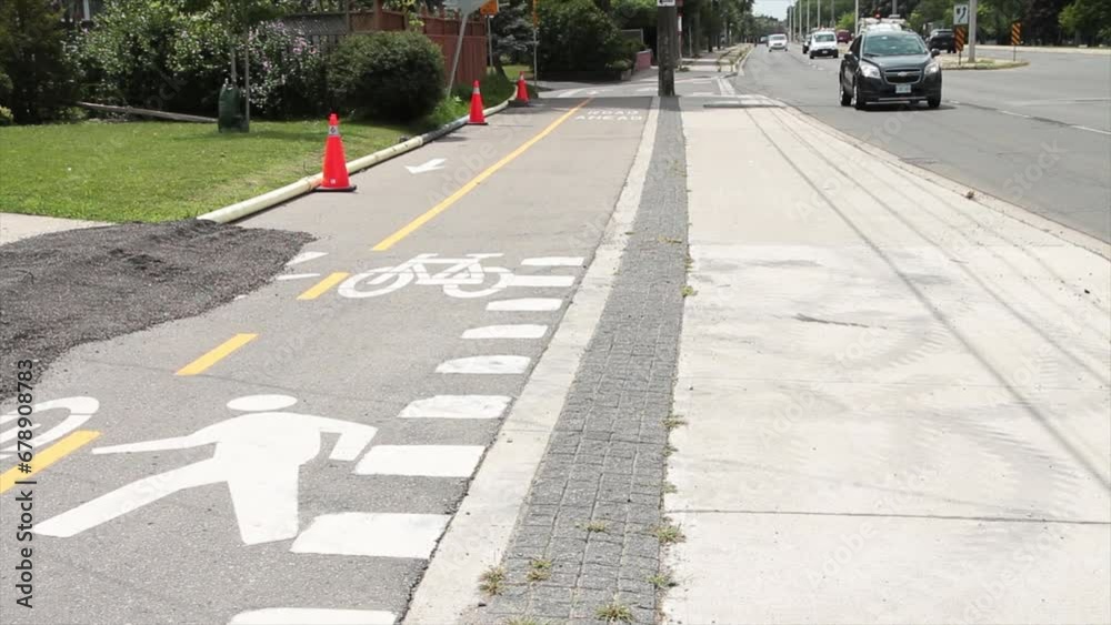 bike bicycle pedestrian path next to road street with stencil outline ...
