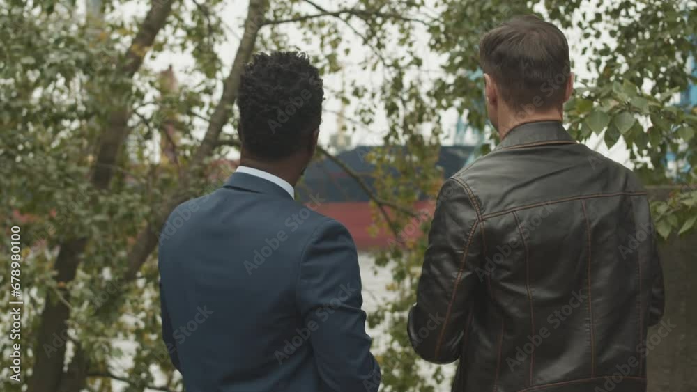 Back view medium shot of African American male police officer in suit ...