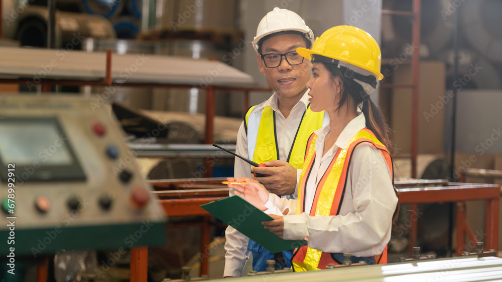 Factory foreman worker and engineer conduct inspection of industrial ...