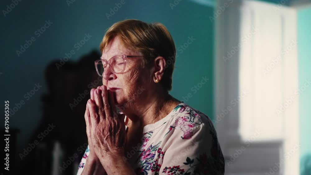 Religious older woman Praying to God in bedroom. Hopeful Elderly Mature ...
