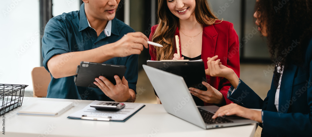 Diverse group of professionals engaging in discussion with laptop and ...