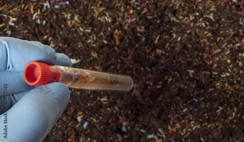 Microplastics in soil a test tube with soil sample - soil contaminated ...