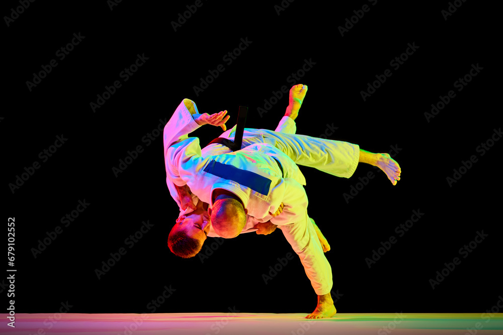 Two young man professional judoist fighting, performing technical skill ...