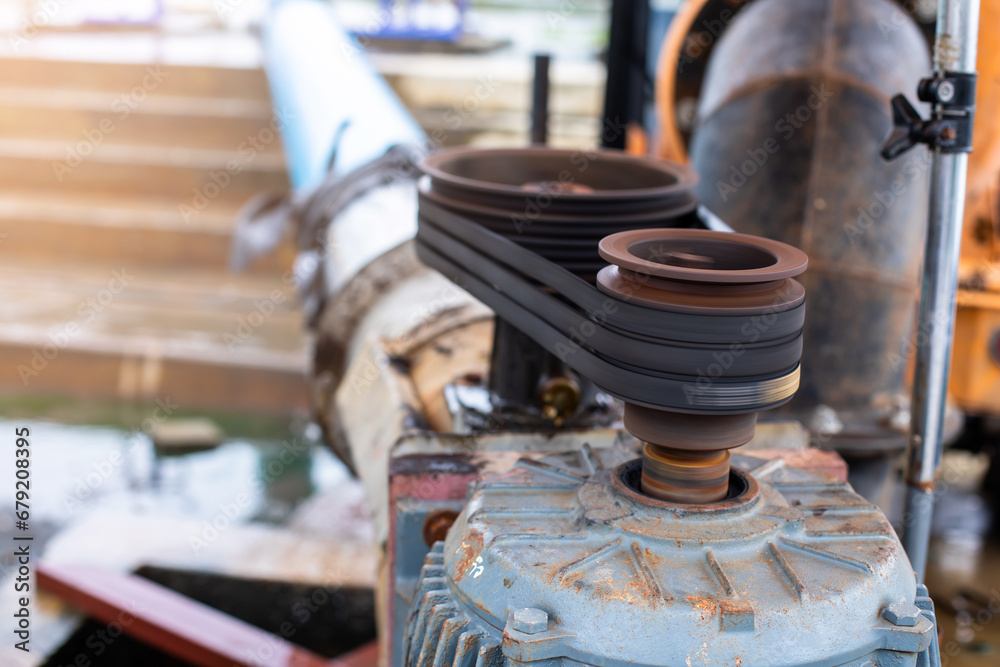 Selective focus to pulley and belt of water pump motor. Belt drive ...