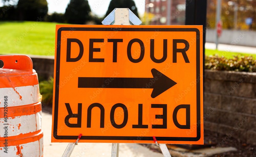 orange construction sign against a blue sky, symbolizing progress and ...