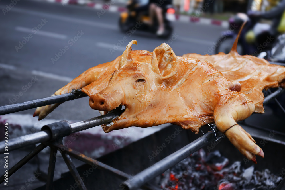 Crispy pig grilled on spit traditional coal and fire. A whole pig ...