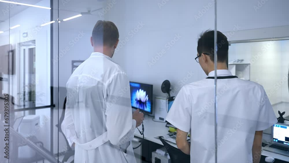 A doctor observes how the patient's magnetic resonance imaging MRI is ...
