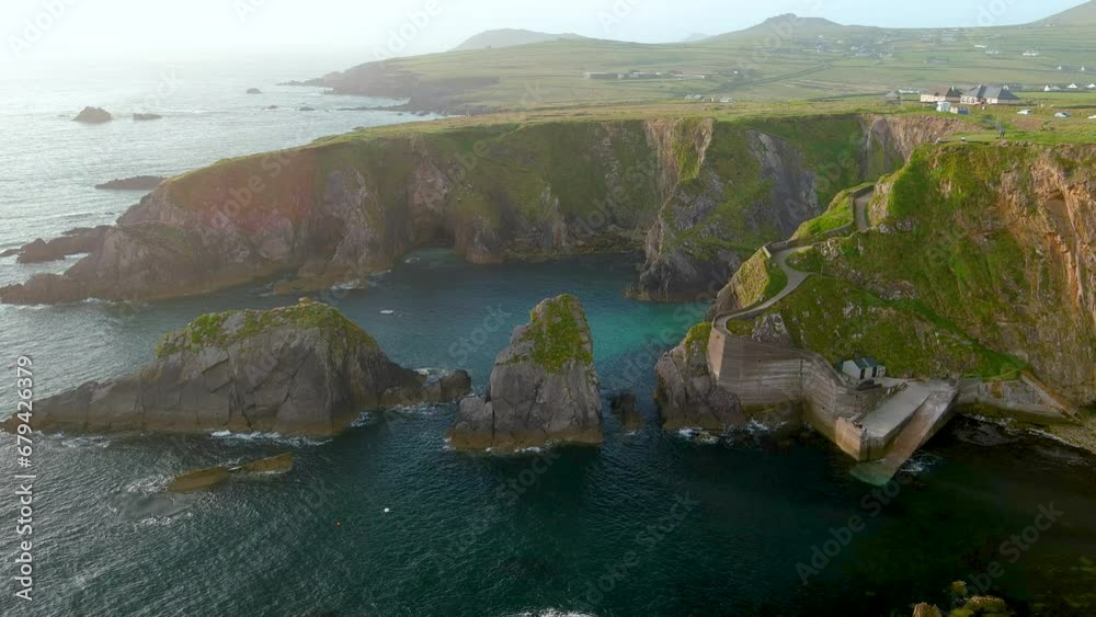 Dunquin or Dun Chaoin pier, Ireland's Sheep Highway. Aerial view of narrow pathway winding down ...