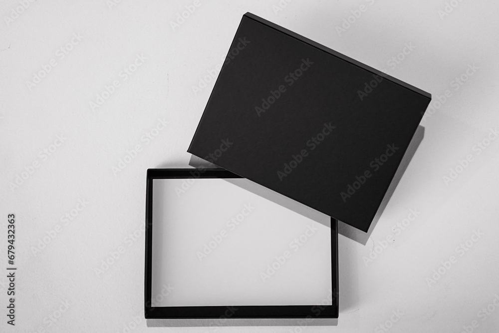 top view of an empty black voucher gift box with white paper ...