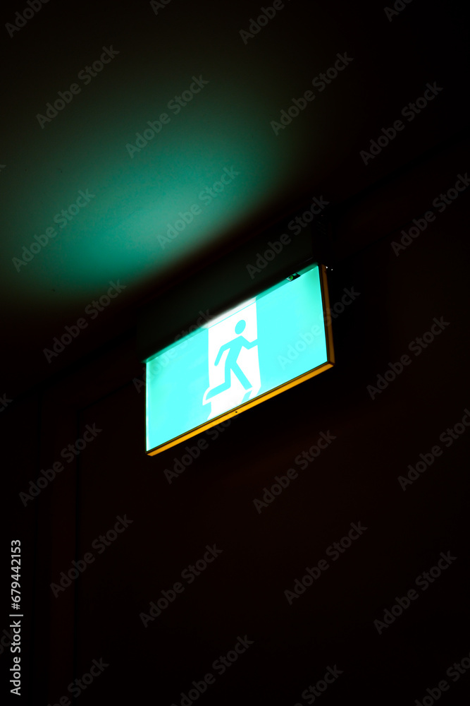 In a building, an emergency exit sign functions as a guiding indicator ...