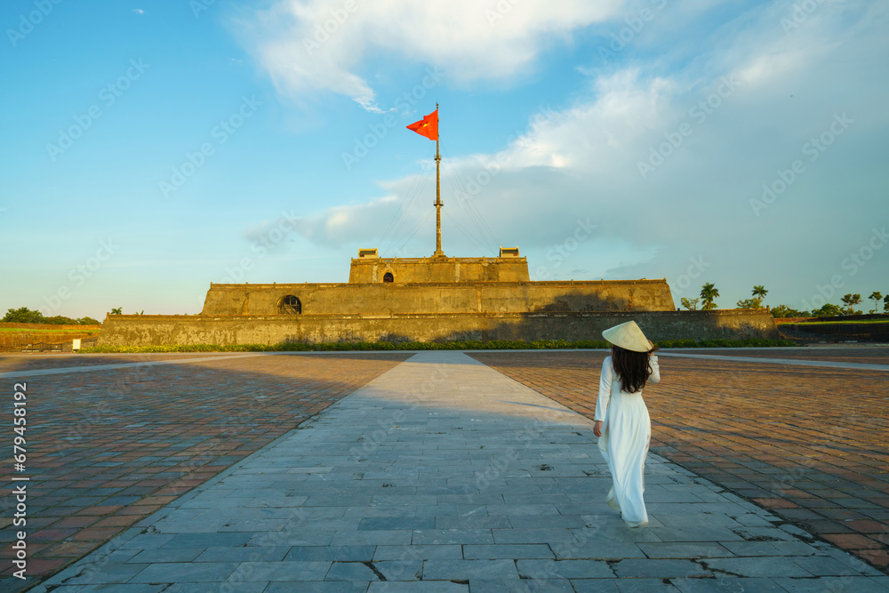Ky Dai flag tower at Ngo Mon square with Vietnamese girl wearing ...