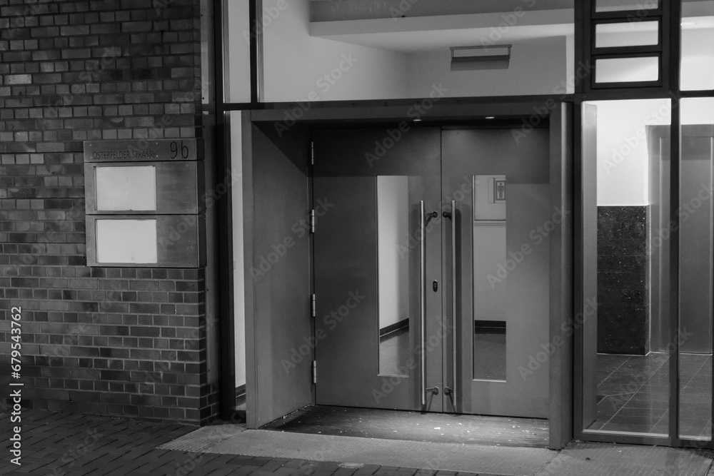 illuminated building entrance with stairs at night from the outside ...