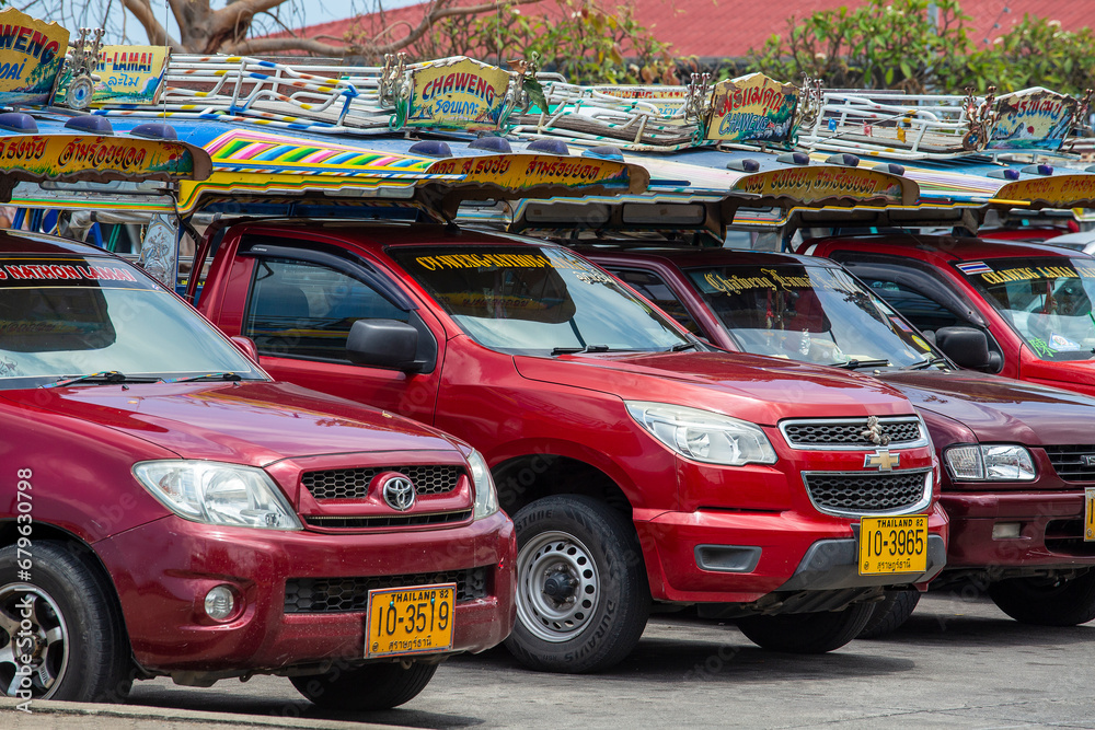 Songthaew pick-up truck at Nathon pier in Koh Samui. Songthaews are ...