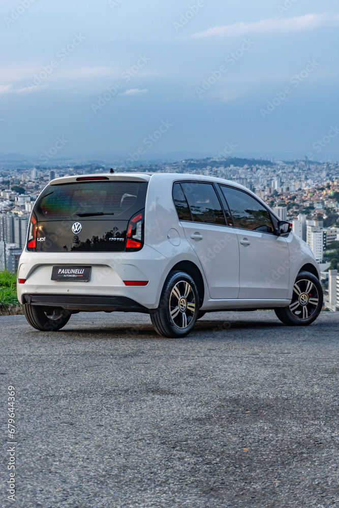 White Volkswagen UP TSI rear end view, city landscape background - High ...