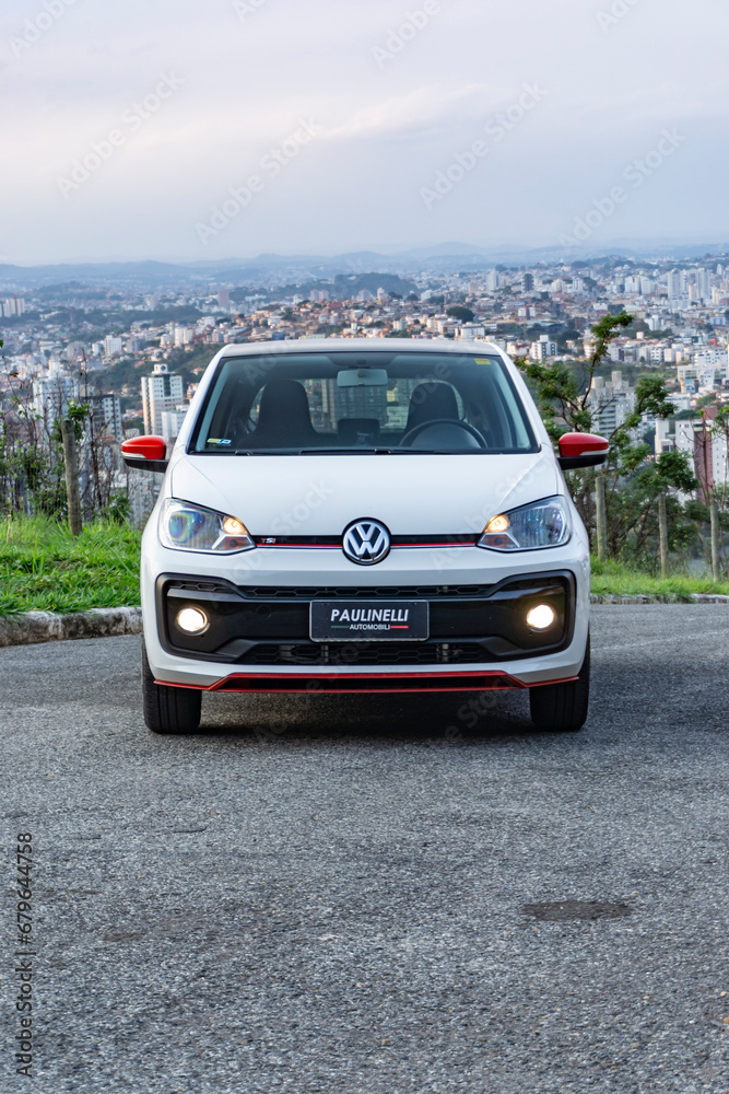 White Volkswagen UP TSI front view, city landscape background ...