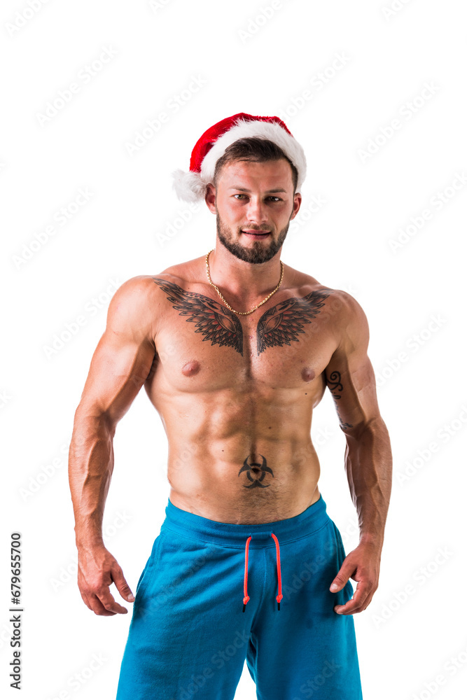 Christmas season: muscular bodybuilder shirtless wearing Santa Claus ...