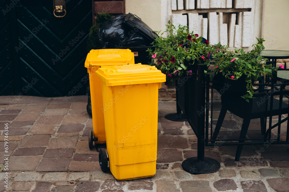 Yellow recycling cans out on the street for pick up. Trash recycle. Bin ...