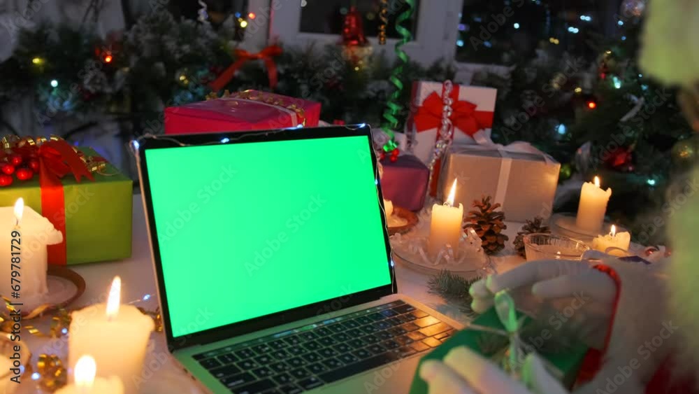 Grandfather Santa Claus sitting at laptop with mock up chroma key ...