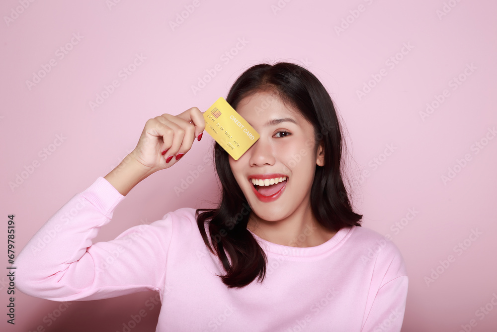 Asian woman holding a credit card in her hand Holding a debit card in ...