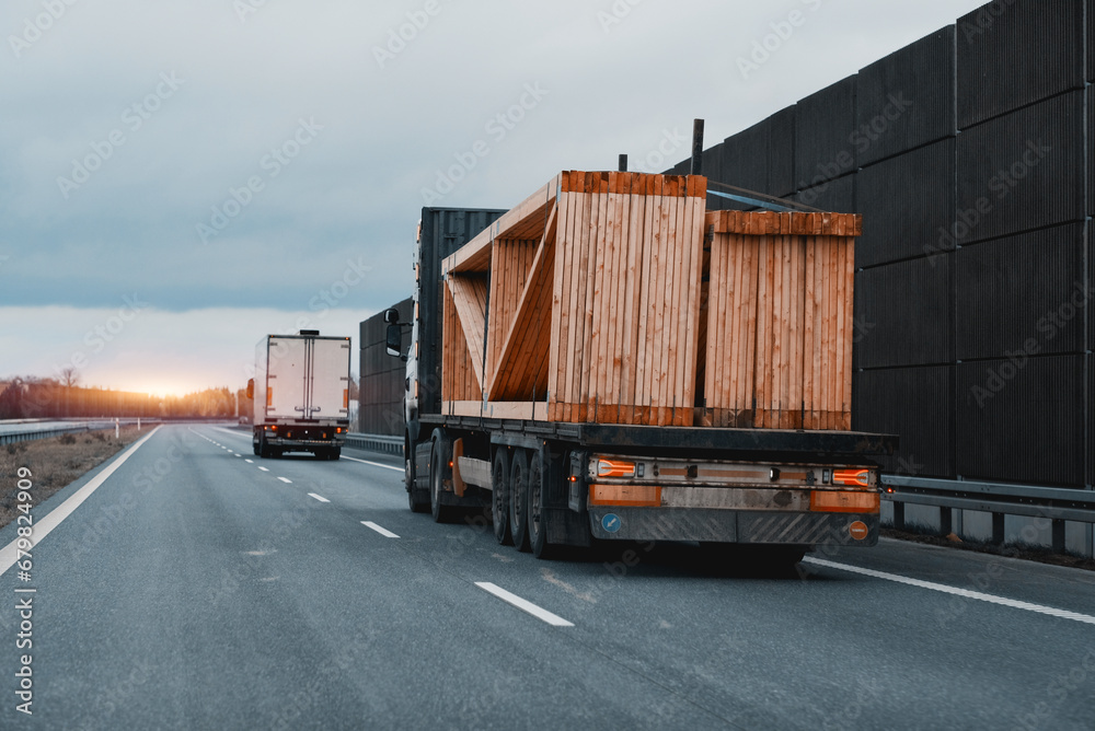 Transportation of timber wooden construction. Cargo for wood factories ...