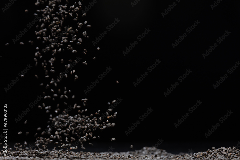 Black Sesame seeds flying explosion, black grain wave floating ...
