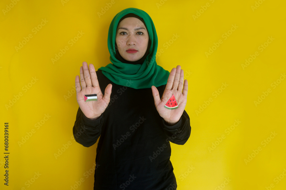 Muslim woman in hijab showing hands painted with Palestine flag and ...