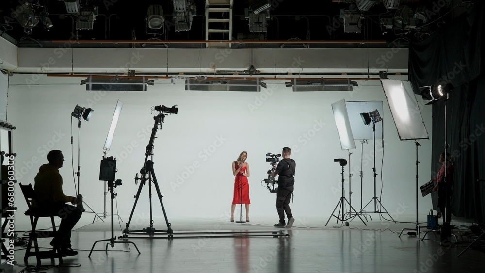 Professional filming pavilion with a white cyclorama. Shooting of a ...