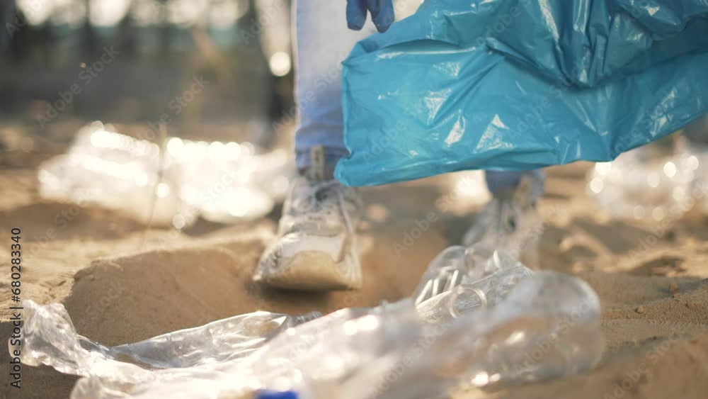 Teamwork.Cleaning plastic garbage in bag on beach in summer ...