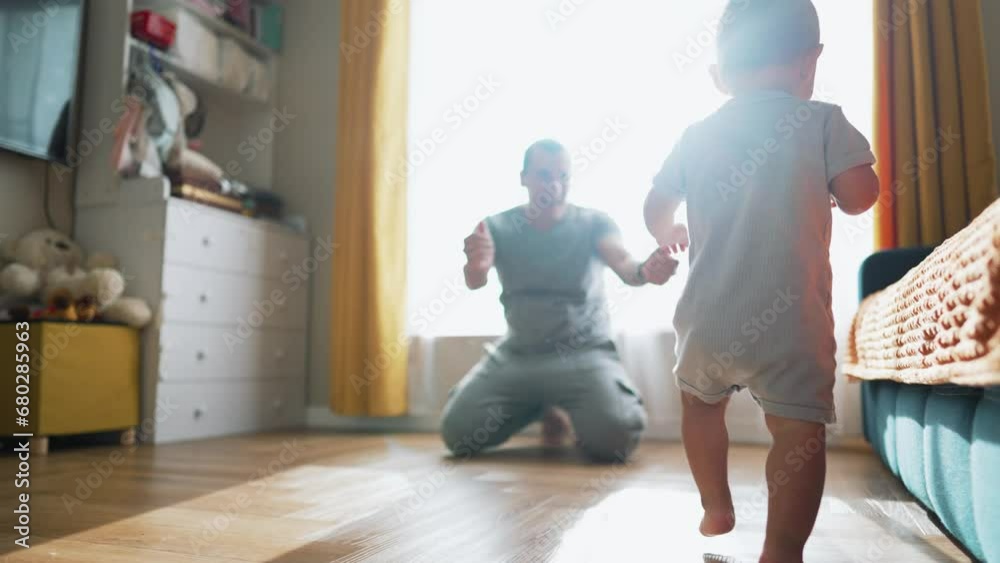 Baby first steps.Child kid runs across floor to family.kid learn to walk and run with help of ...