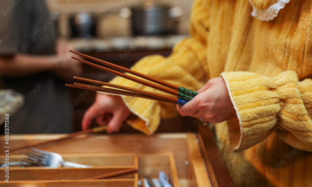 wooden chopsticks resting on a ceramic dish, depicting Asian dining ...