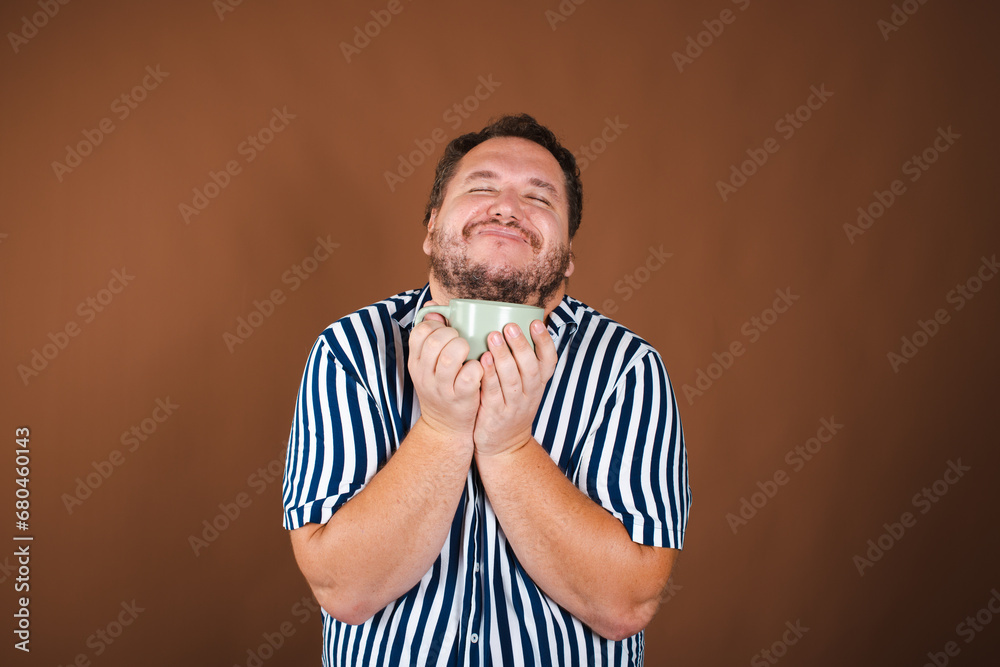 Early morning and various news. Funny fat man with a mug of coffee ...