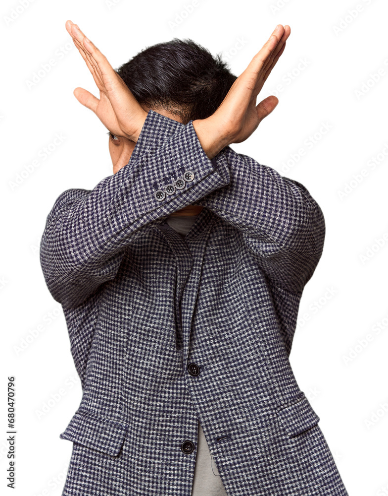 Young Chinese man in studio background keeping two arms crossed, denial ...