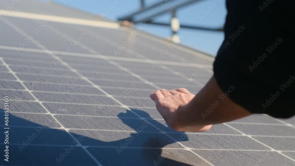 A person's hand on solar panels. Harnessing solar energy for ...