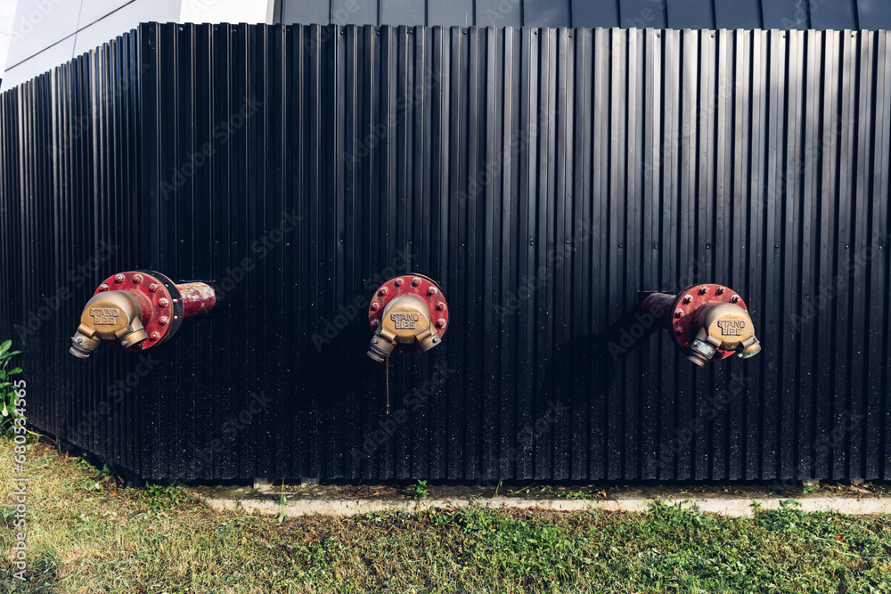 Red fire pump in front of concrete wall. fire safety pump on cement ...