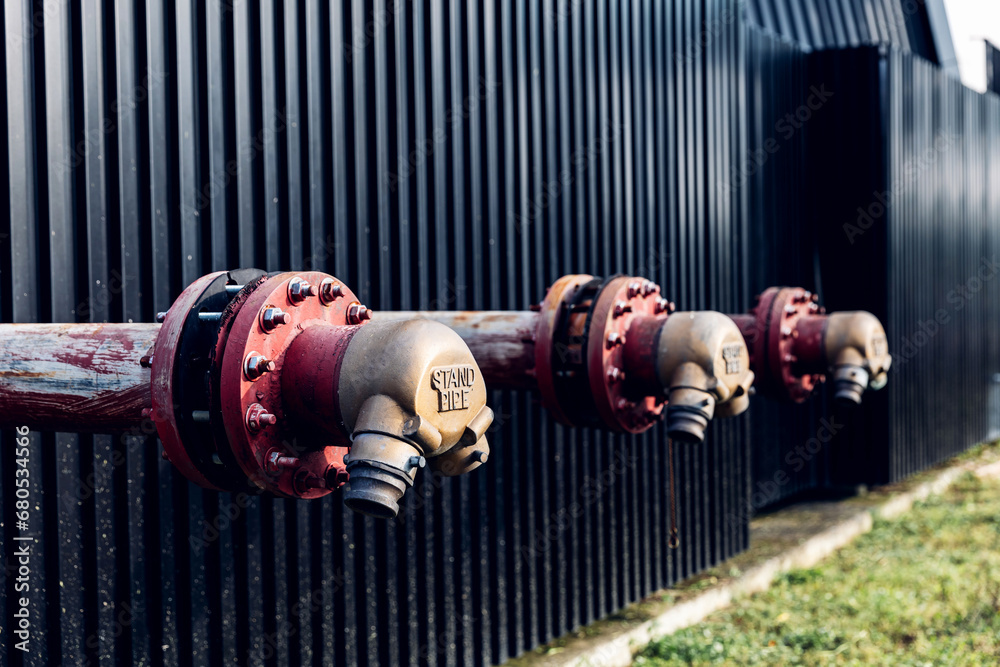 Red fire pump in front of concrete wall. fire safety pump on cement ...