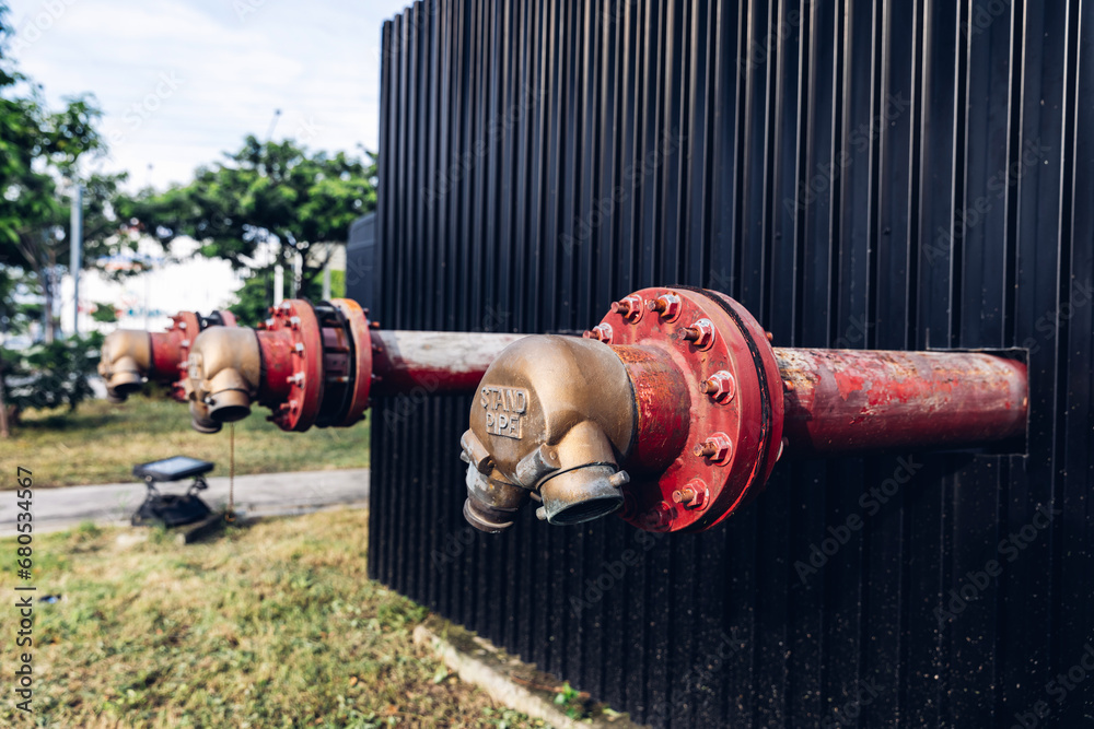 Red fire pump in front of concrete wall. fire safety pump on cement ...