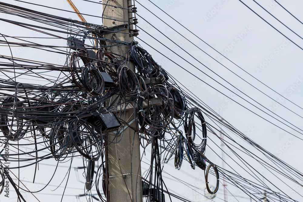 Intertwined electric wires. A tangled electrical wires showcasing the ...