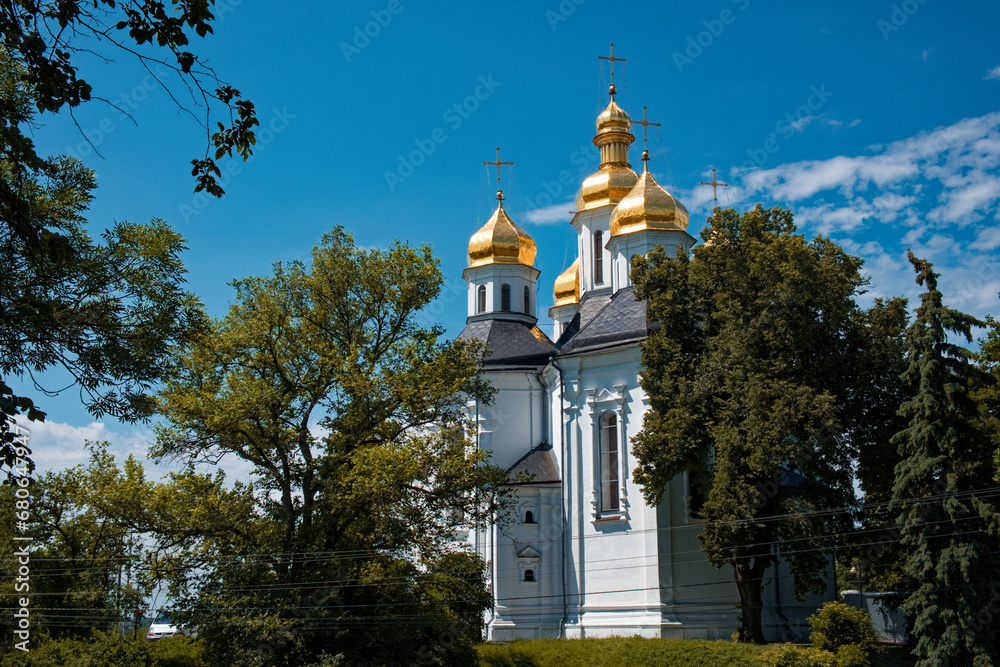 A white church with golden domes and crosses on top. Catherine's Church ...