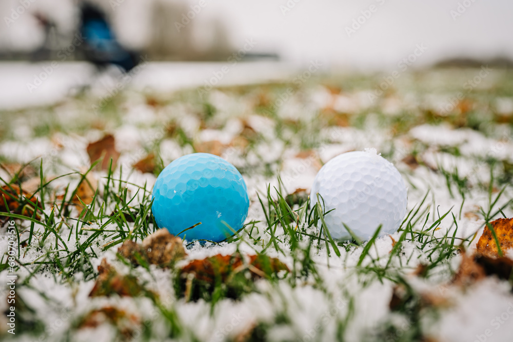 Two golf balls stand in the snow to see the difference as you can see ...