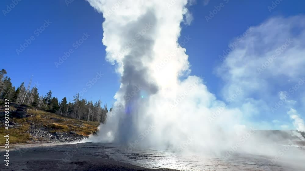 Cinematic Grand geyser Old Faithful sun glare sunrise sunset eruption ...