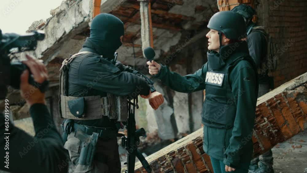 Female war journalist conducting interview with military representative ...