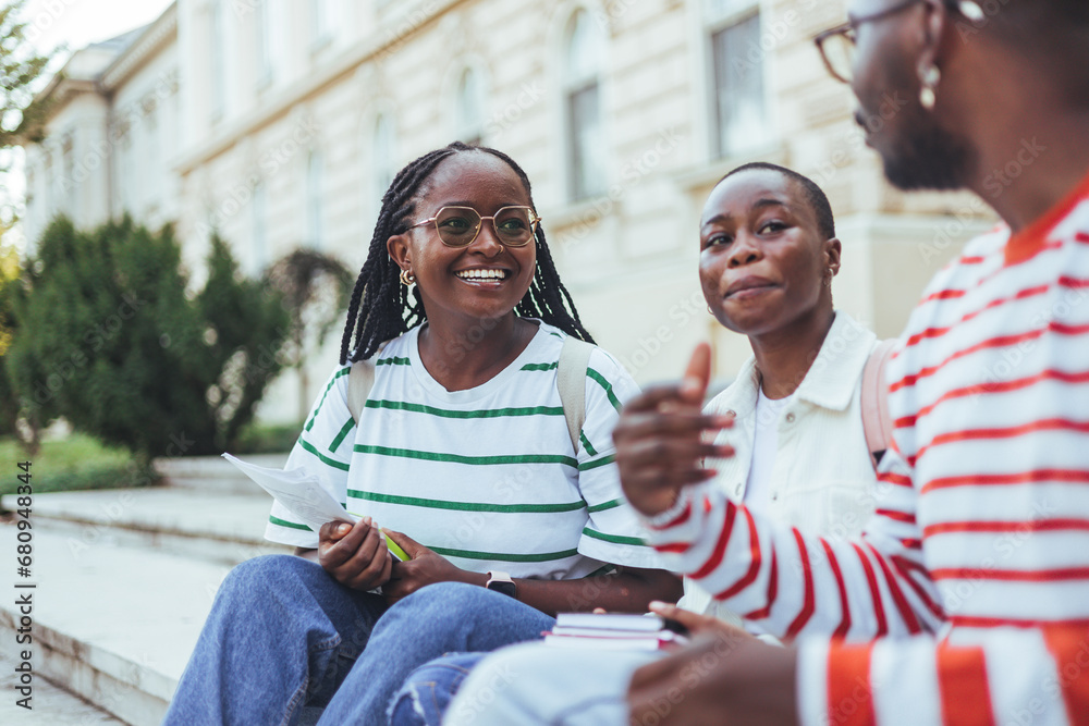 Happy multiethnic group of students smiling outdoor. Front view of four ...