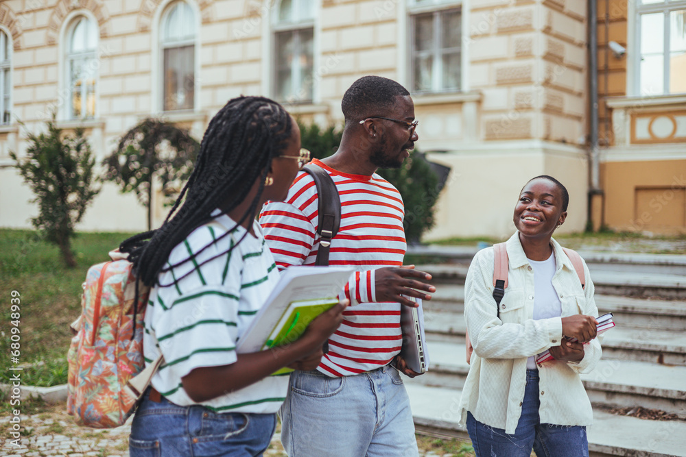 Happy african college friends. Students talking at arriving at school. Happy african american ...