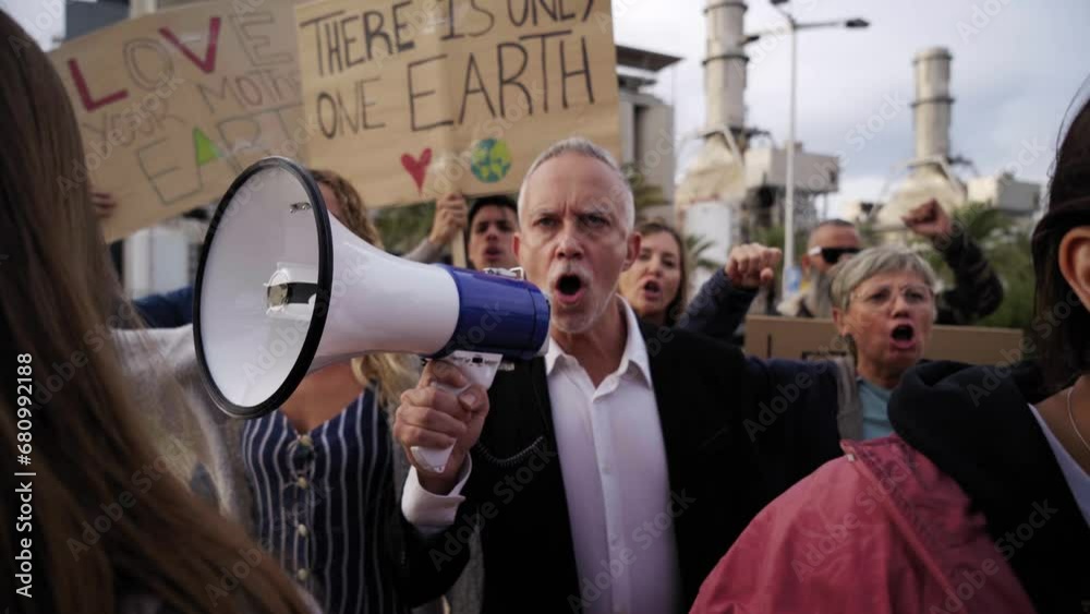 Pro-earth demonstration with banners for climate change. Man with ...