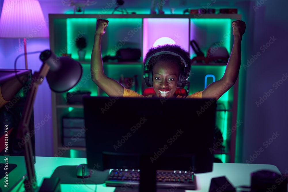 African american woman streamer using computer with winner expression ...